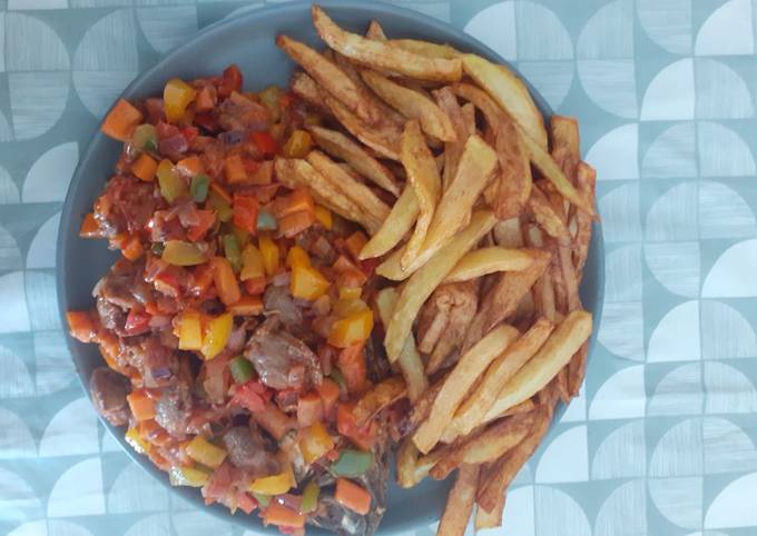 Potato chips and fried fish with peppered soup garnish with vegetables ...
