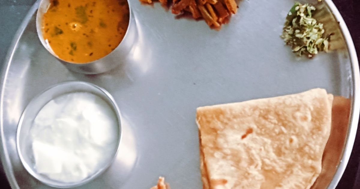 Traditional Maharashtrian Thali. Amti,Chapati,Thecha, Bhendi,Dahi,Gud ...